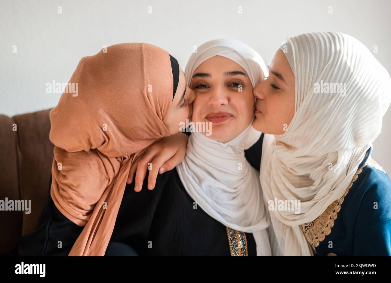 Happy Muslim family at home young mother and two child daughters in ...