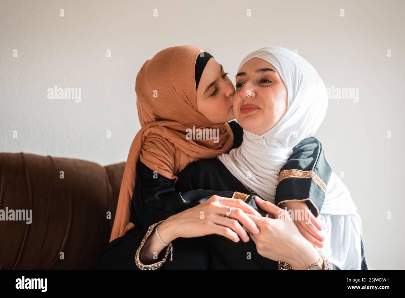 Happy Muslim family at home young mother and child daughter in hijab ...