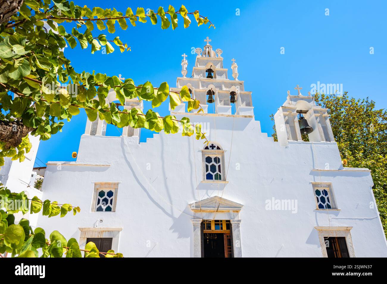 White facade of typical Greek church in historic Filoti village, Naxos ...