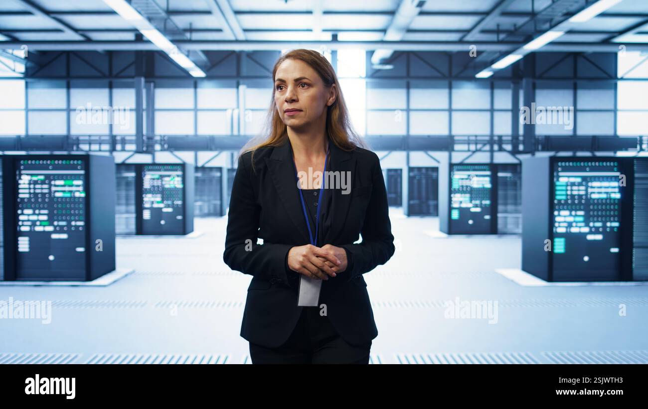 Admin walking in data center, monitoring systems to identify root cause ...