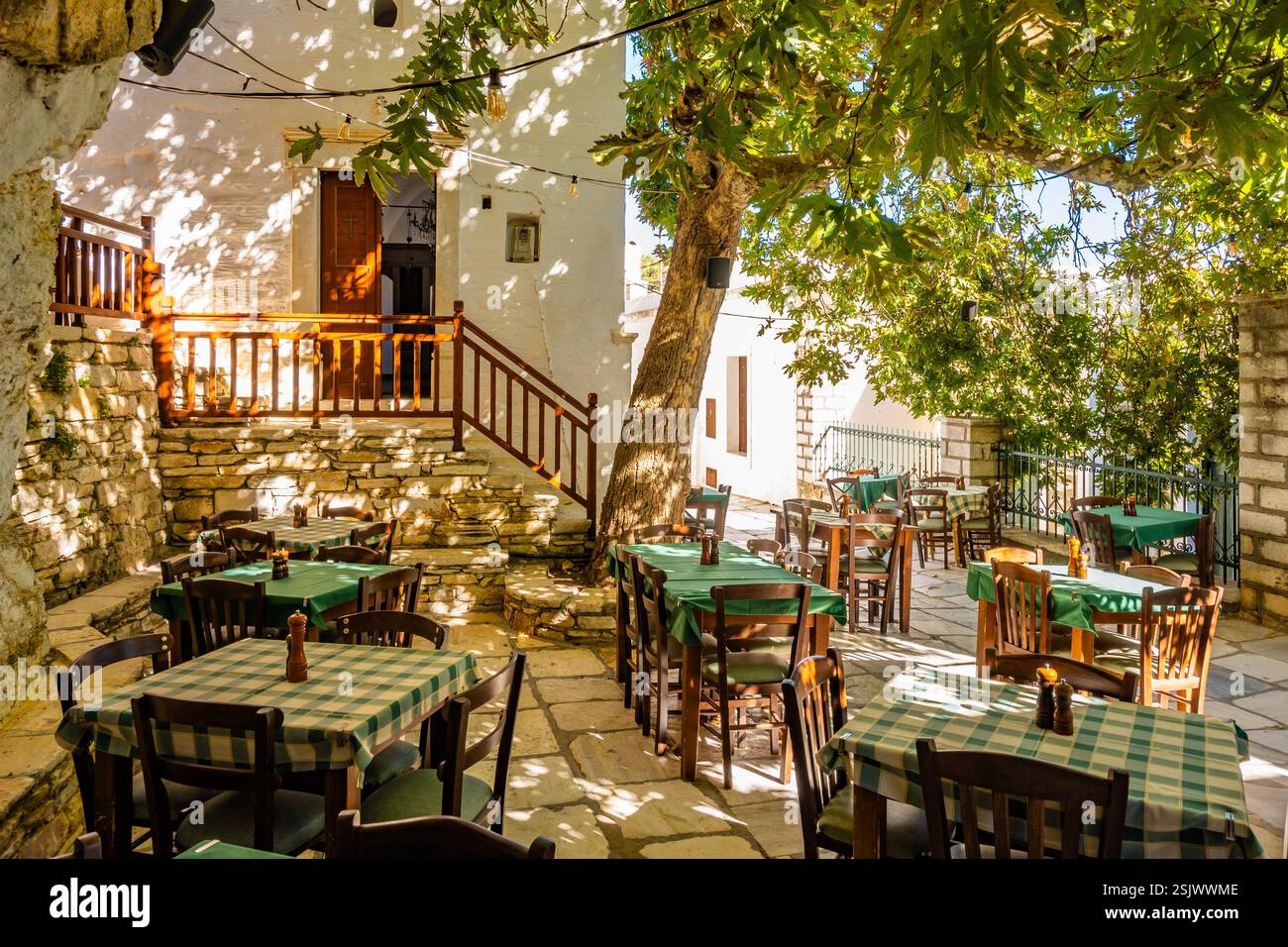 Tables with chairs in Greek taverna restaurant in Koronos mountain ...