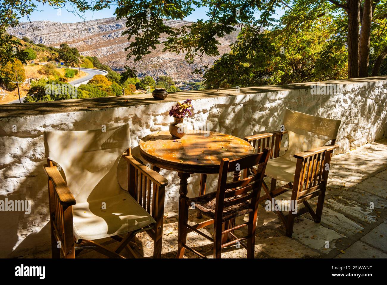 Tables with chairs in Greek taverna restaurant in Koronos mountain ...