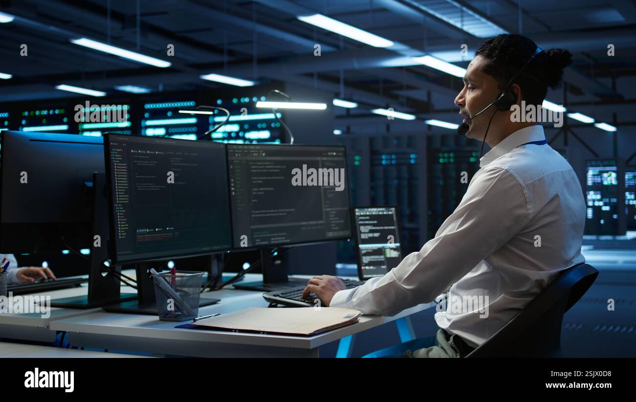 Data center computer scientist wearing mic headset, doing installation of networking equipment ...