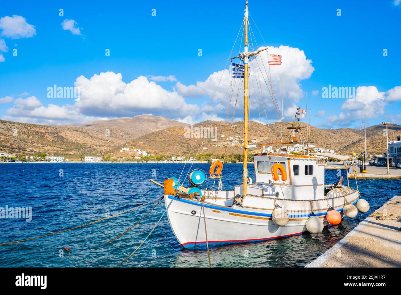 Traditional fishing boat anchoring in small port of Katapola village ...