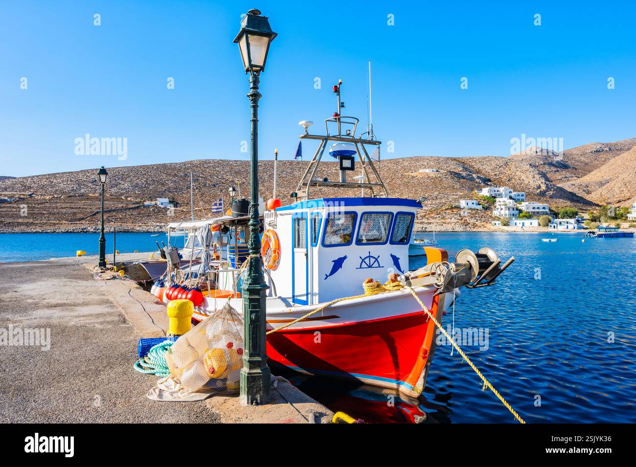Traditional fishing boat anchoring in Karavostasis port, Folegandros ...
