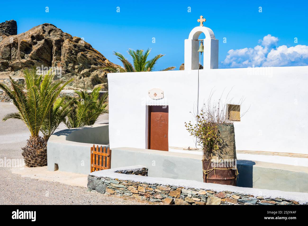 Typical whitewashed traditional Greek Chrysopigi chapel with palm trees ...
