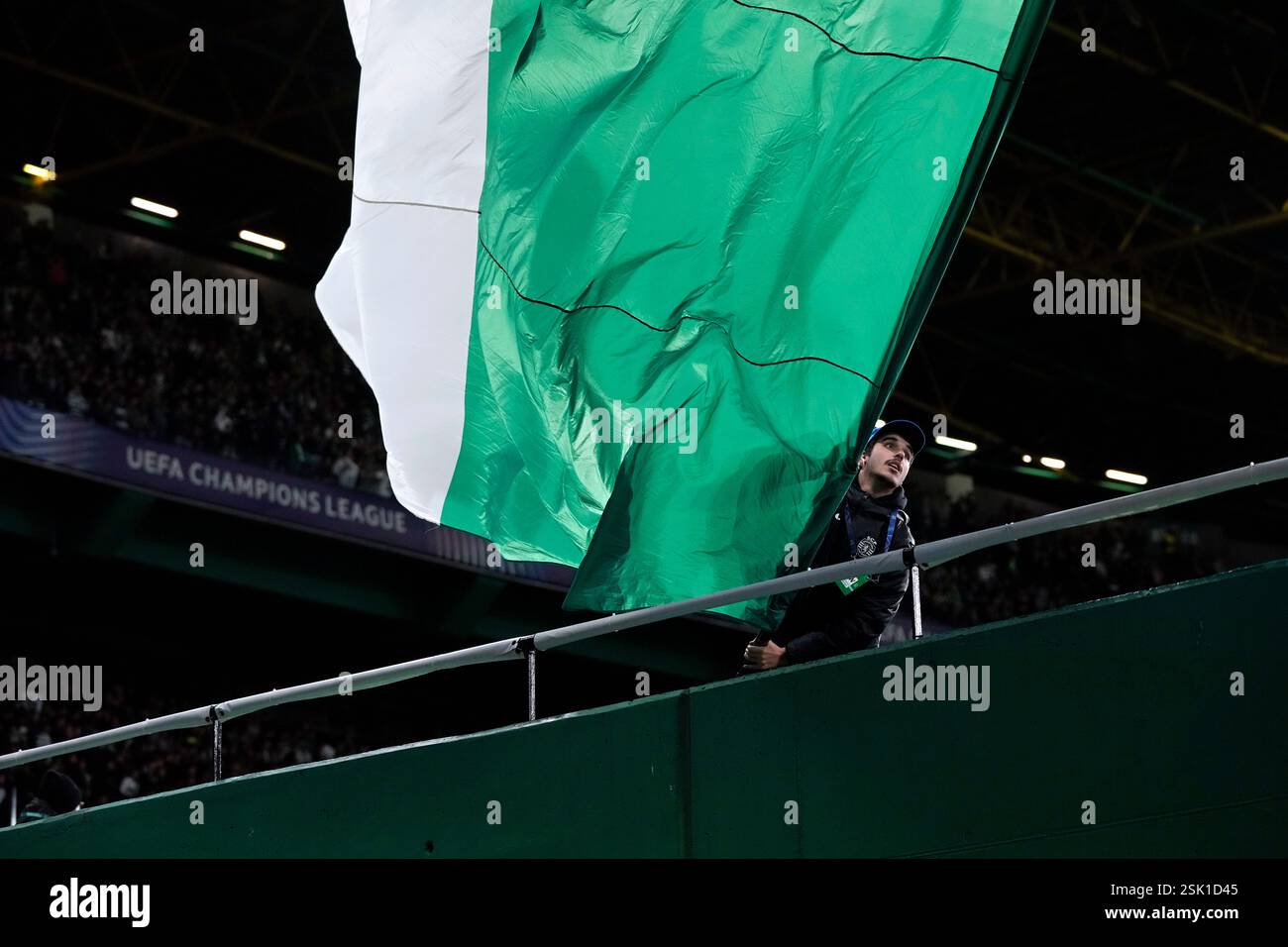 A volunteer waves a Sporting flag before the Champions League playoff ...