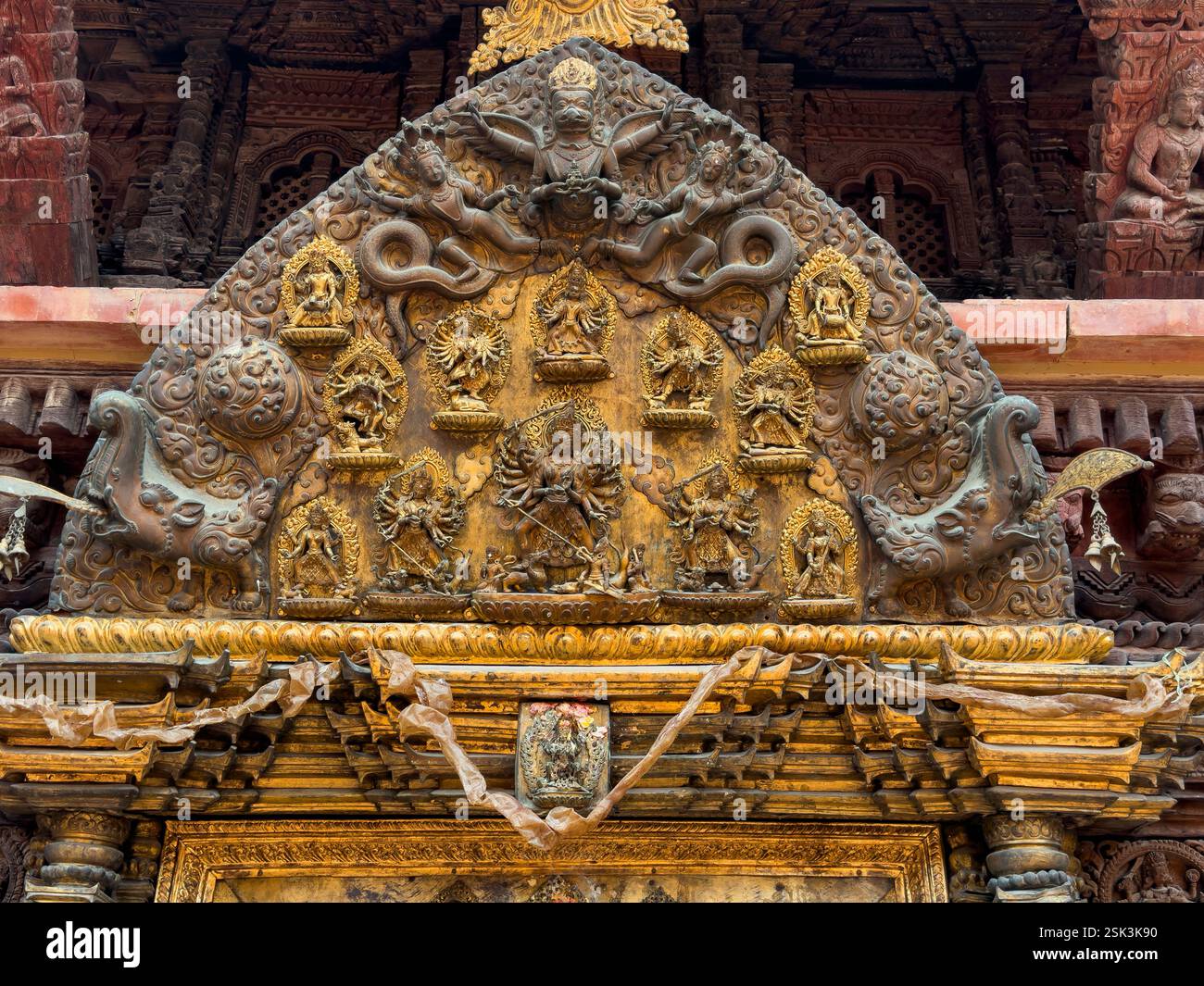 A Newari Buddhist gold plated lintel over a door in a Patan Newari ...