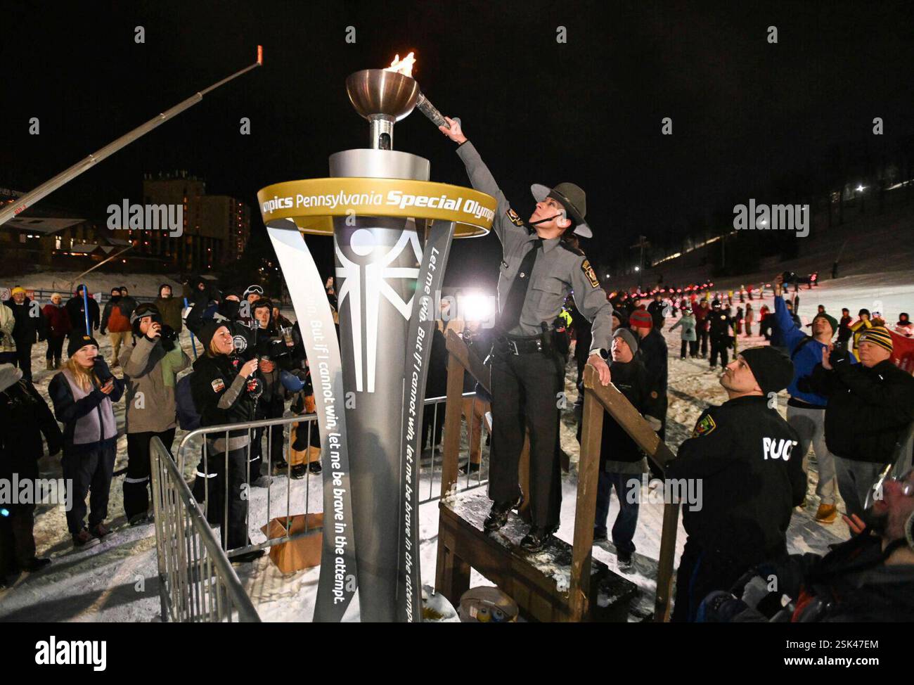 Pennsylvania State Trooper Tabitha Jacoby lights the cauldron during ...