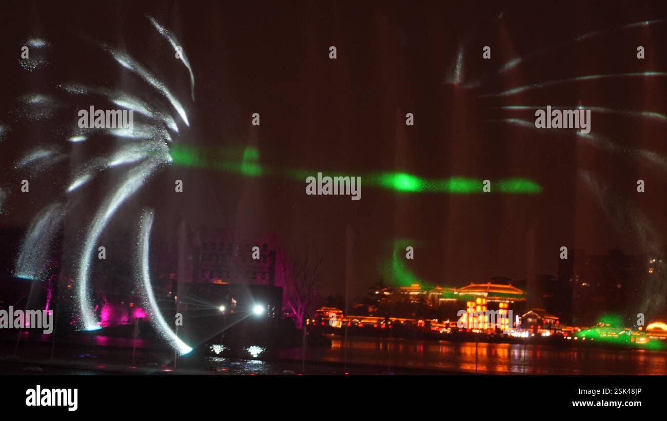 XI'AN, CHINA - FEBRUARY 11, 2025 - Tourists watch a laser show at Tang ...
