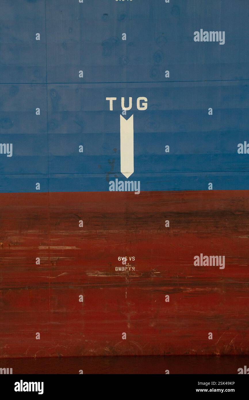 The word tug and a white arrow on a blue and rust background on the ...