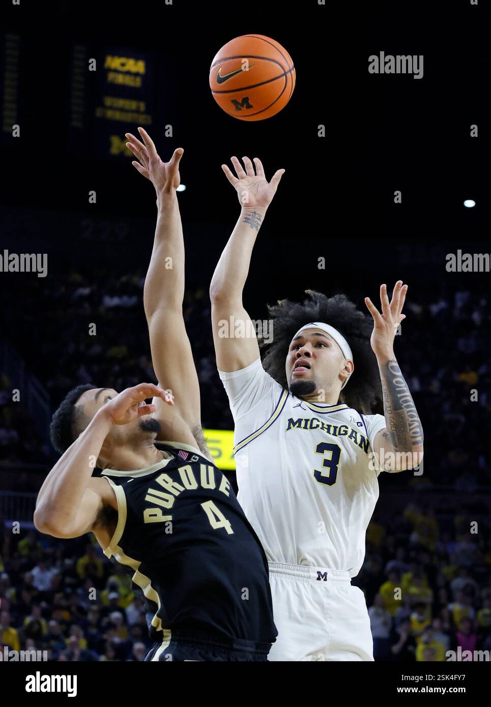 Michigan guard Tre Donaldson (3) takes a shot against Purdue forward ...