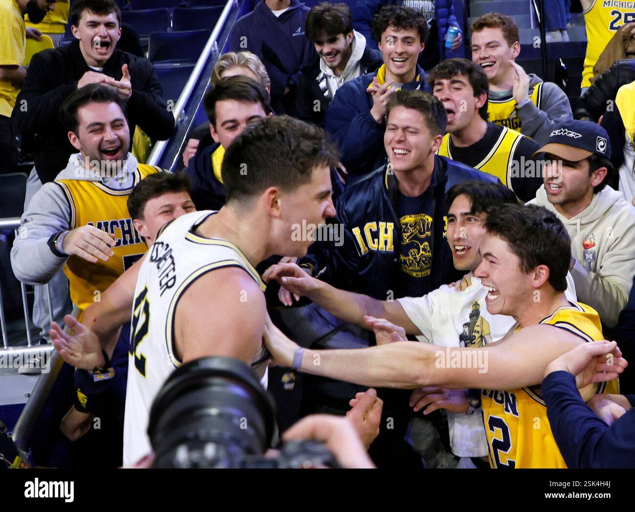 Michigan forward Will Tschetter (42) celebrates with fans after a 75-73 ...