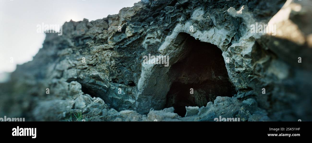 Panoramic view of the opening to a lava cave, Grjotagja Rift cave ...
