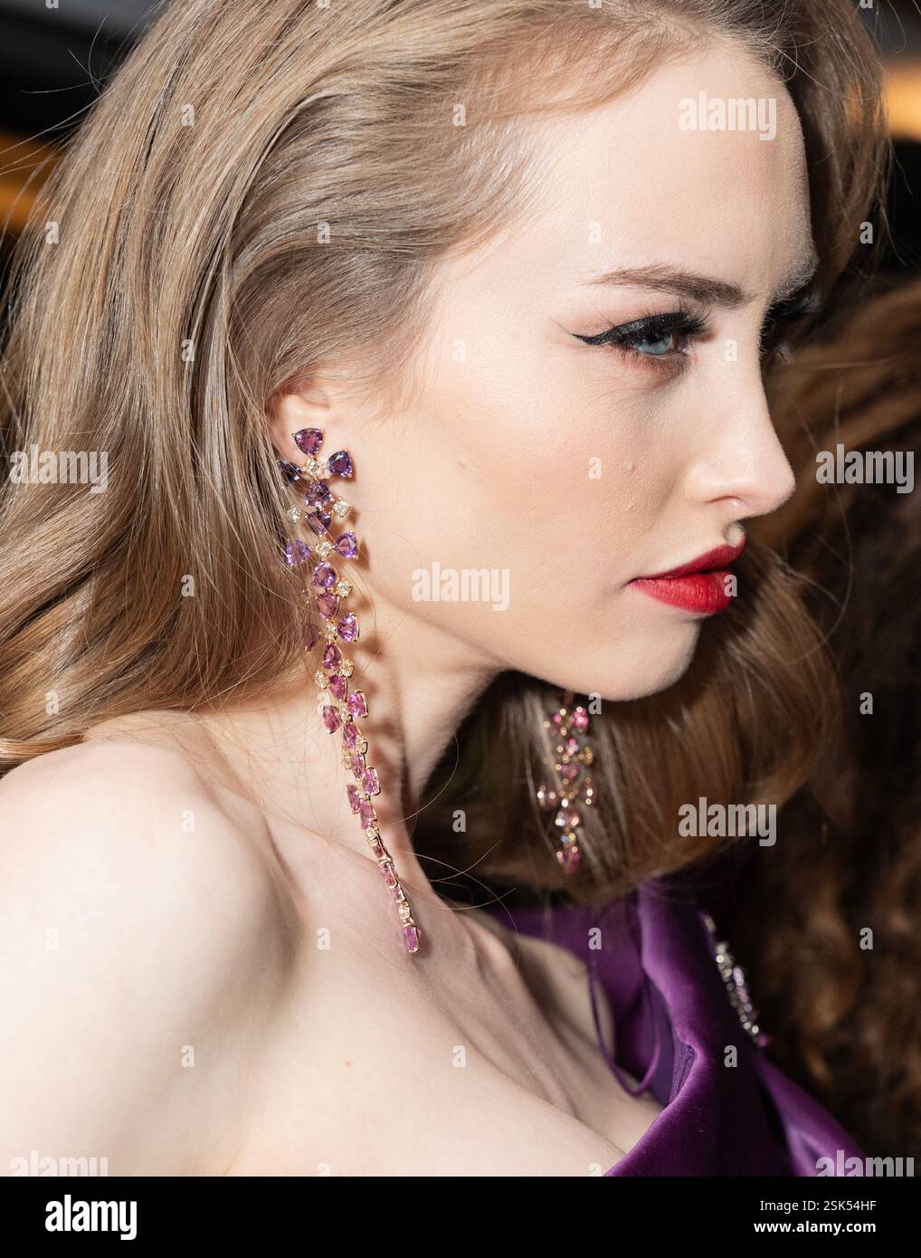 A model wearing jewelry by Chopard prepares backstage for runway for ...