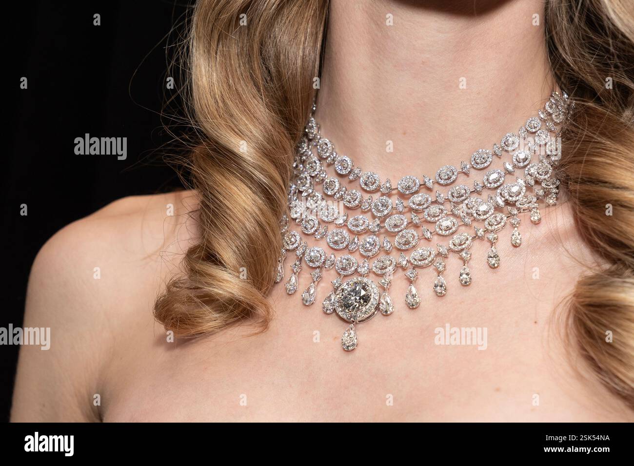 A model wearing jewelry by Chopard prepares backstage for runway for Pamella Roland runway show ...