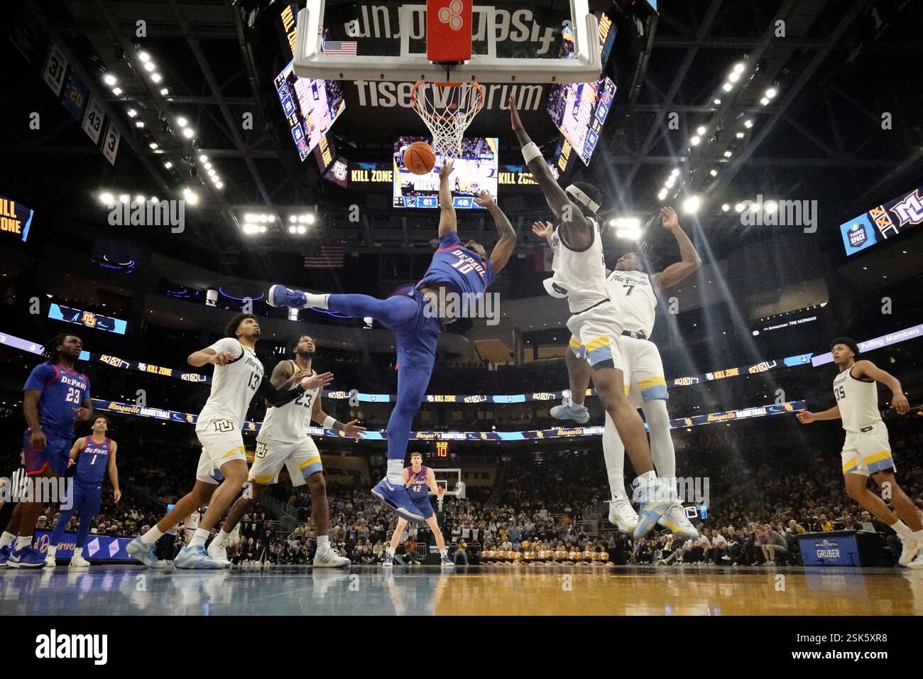 DePaul's Chris Riddle shoots past Marquette's Tre Norman during the ...
