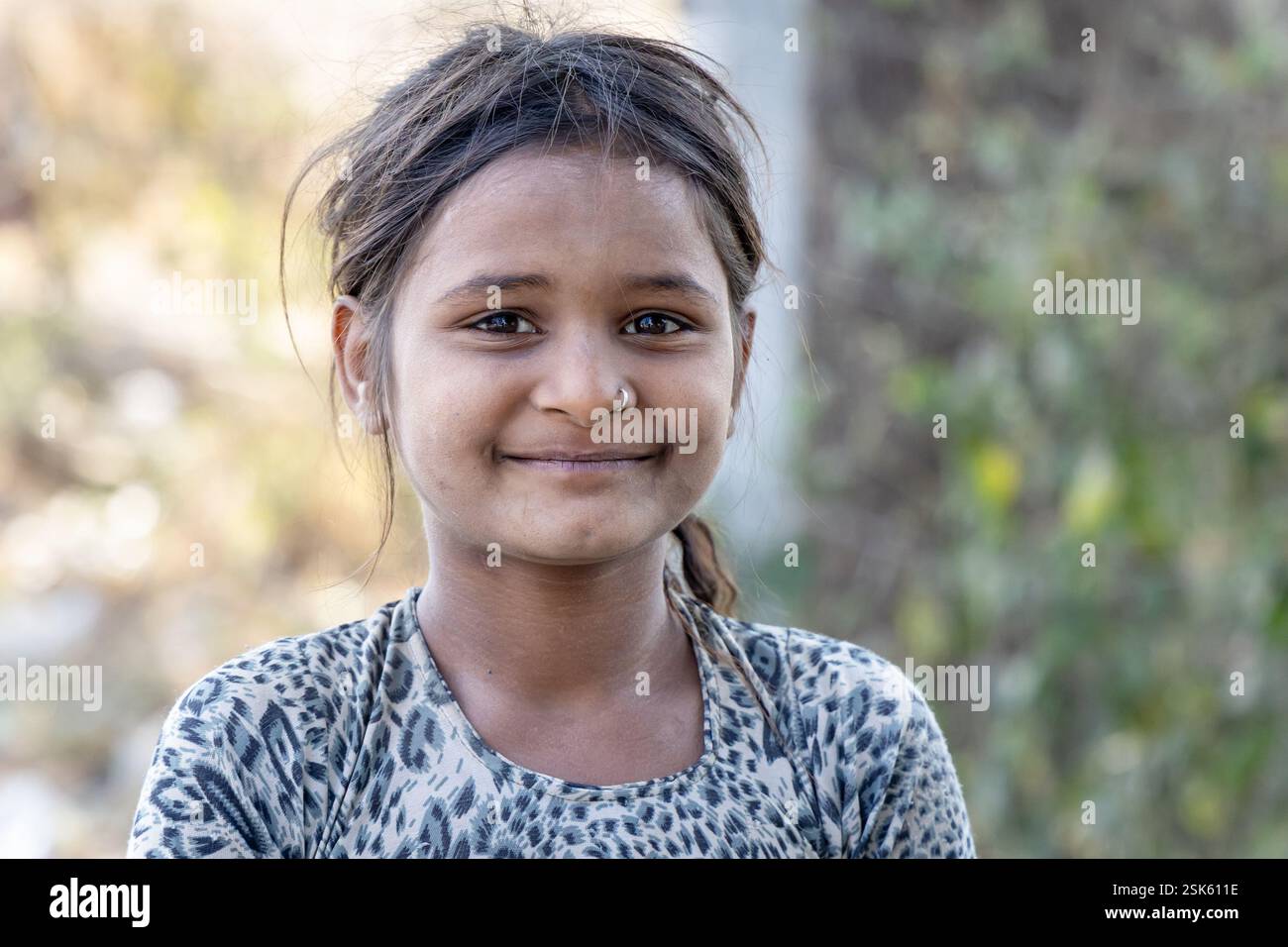 young poor garbage collecting girl with cute smiling facial expression ...