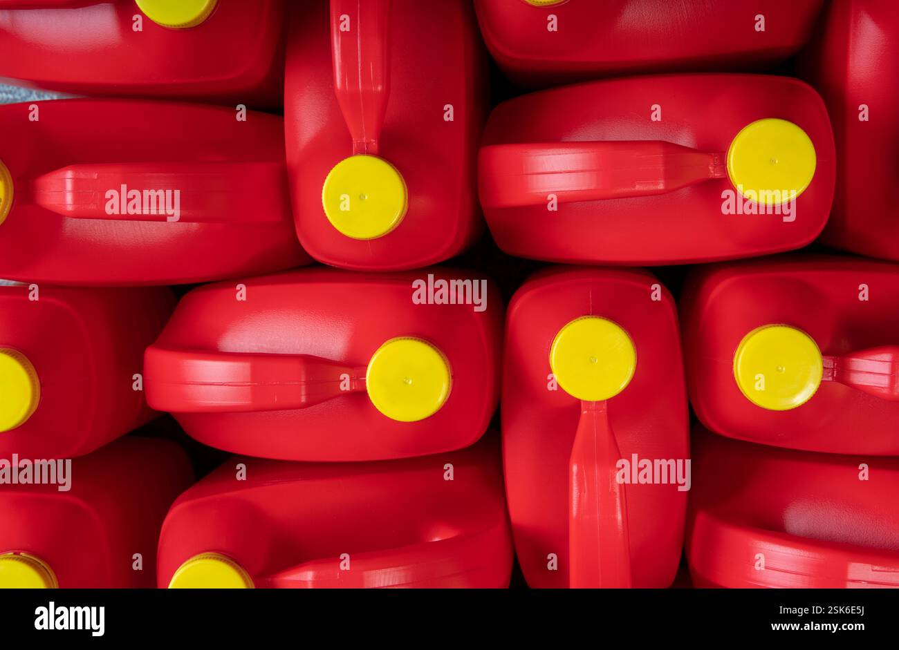 Texture top view of red plastic motor oil bottles, containers with ...