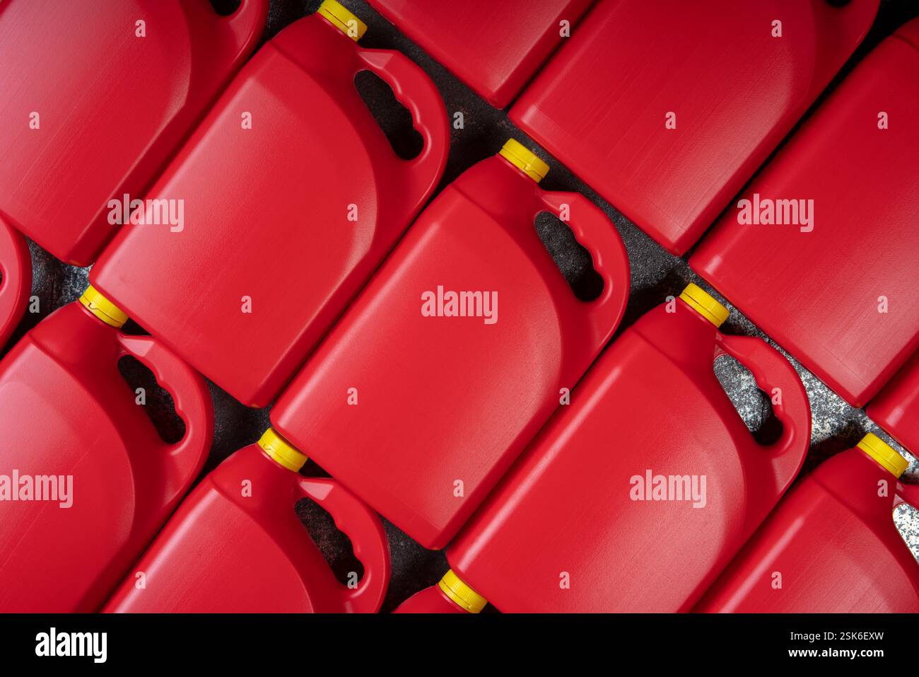 Texture of red plastic motor oil bottles, containers with handle and ...