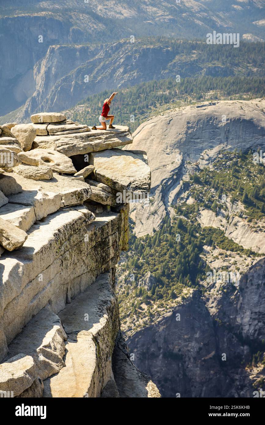 Girl poses on edge of Half Dome summit at Yosemite National Park Stock ...