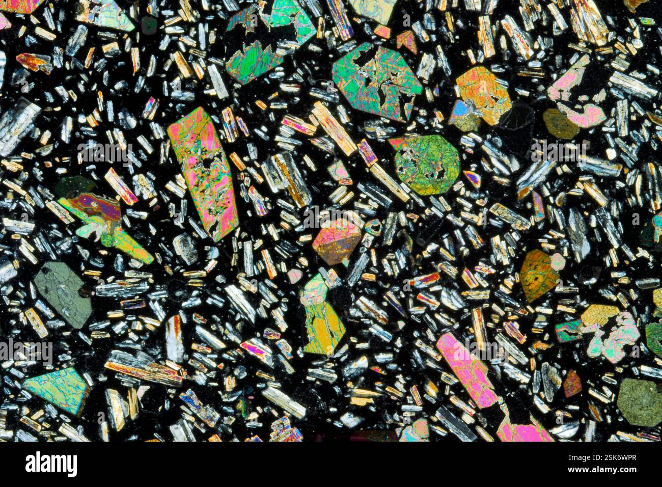 Basalt. Close-up of a thin section of basalt (black). Basalt is a ...