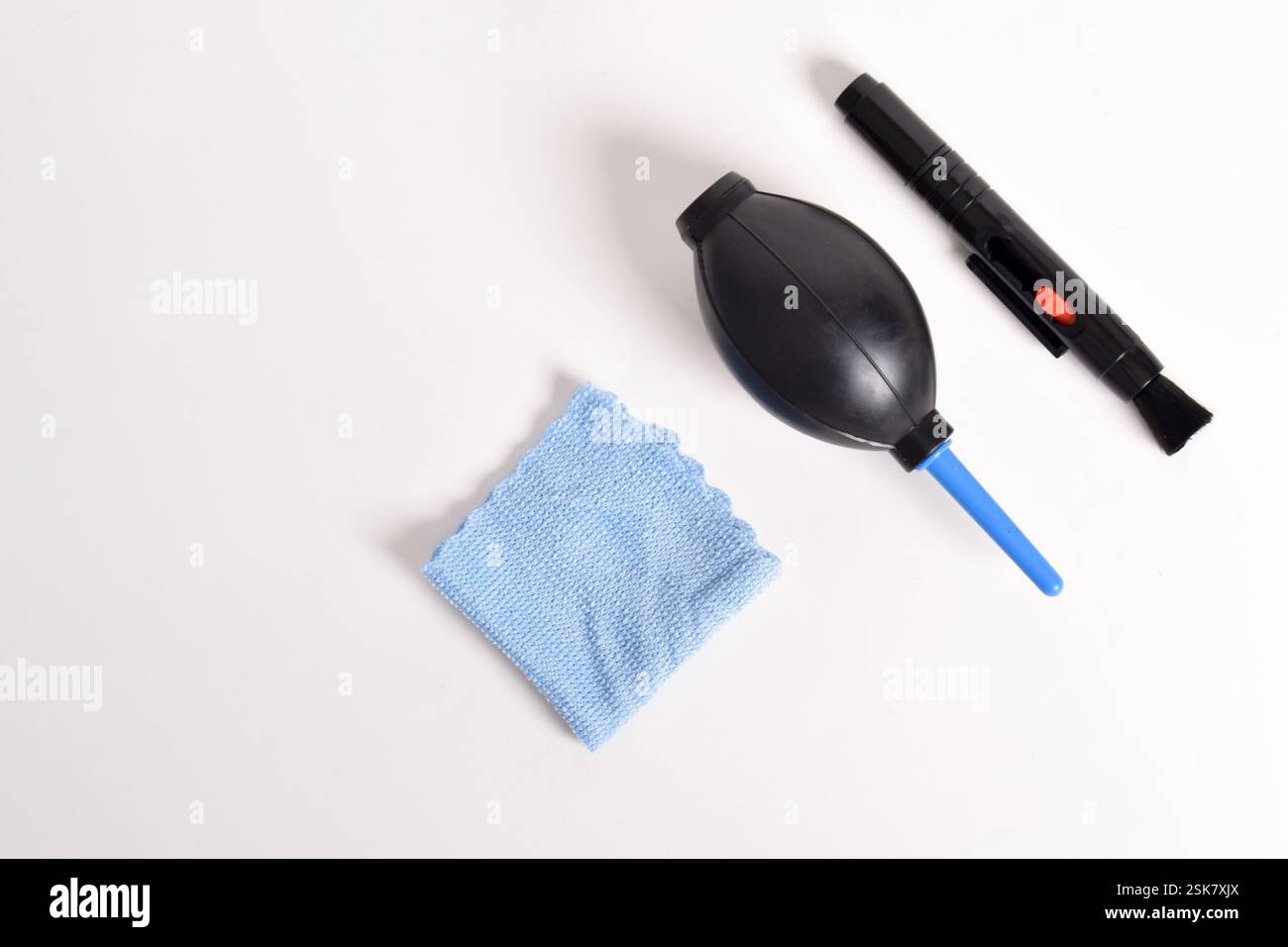 Cleaning set for camera. Air blower, microfiber cloth, brush. Isolated ...