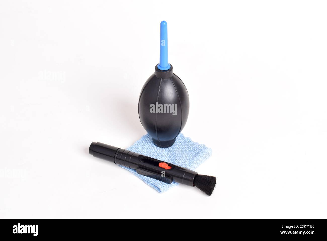Cleaning set for camera. Air blower, microfiber cloth, brush. Isolated ...