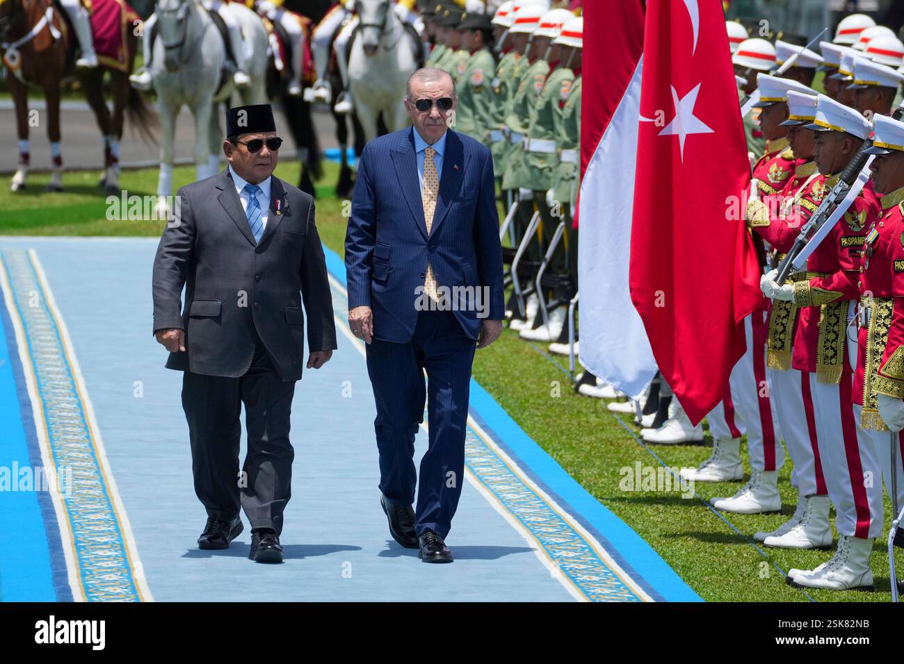Indonesian President Prabowo Subianto, left, walks with Turkey's ...