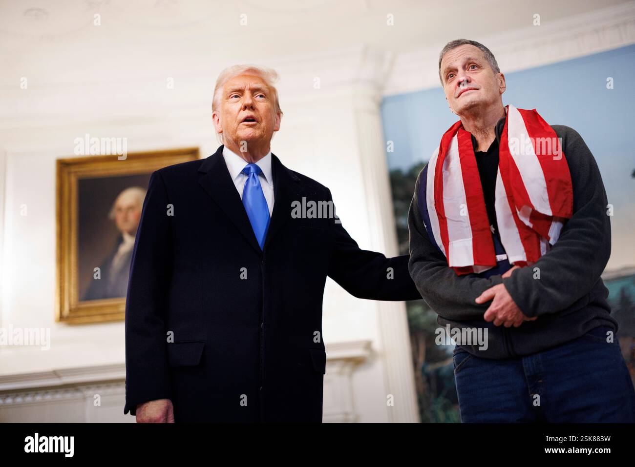 US President Donald Trump greets Mark Fogel, who was recently released ...