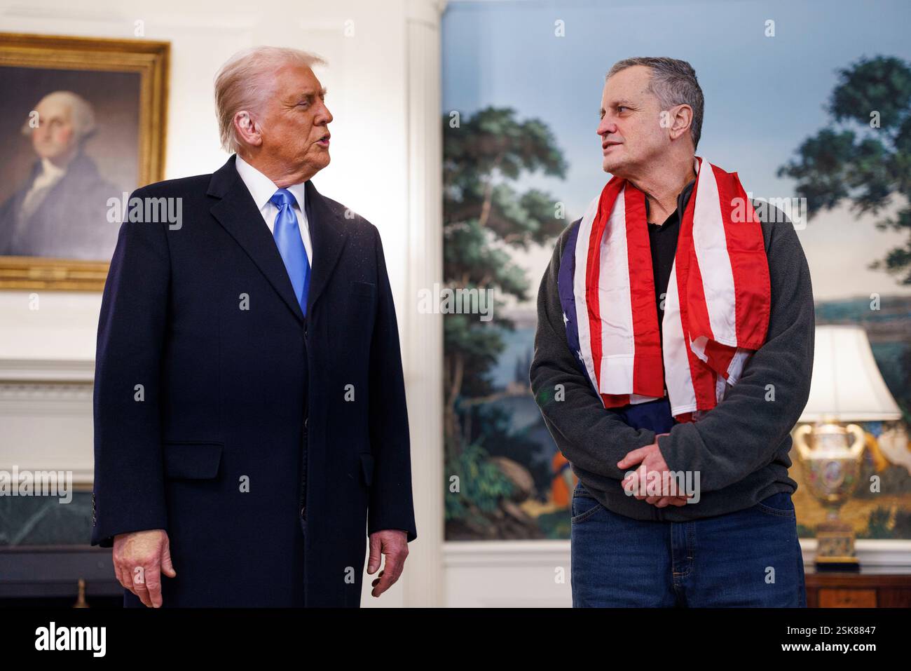US President Donald Trump greets Mark Fogel, who was recently released ...