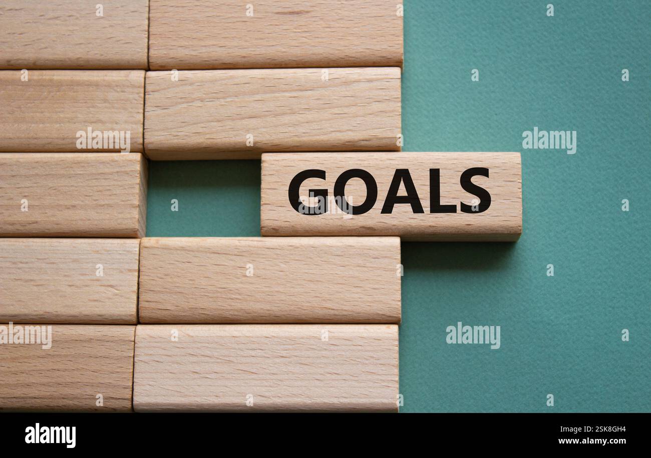 Goals symbol. Concept word Goals on wooden blocks. Beautiful grey green ...