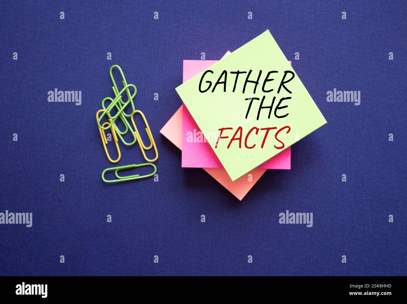 Gather the facts symbol. Yellow steaky note with paper clips with words ...
