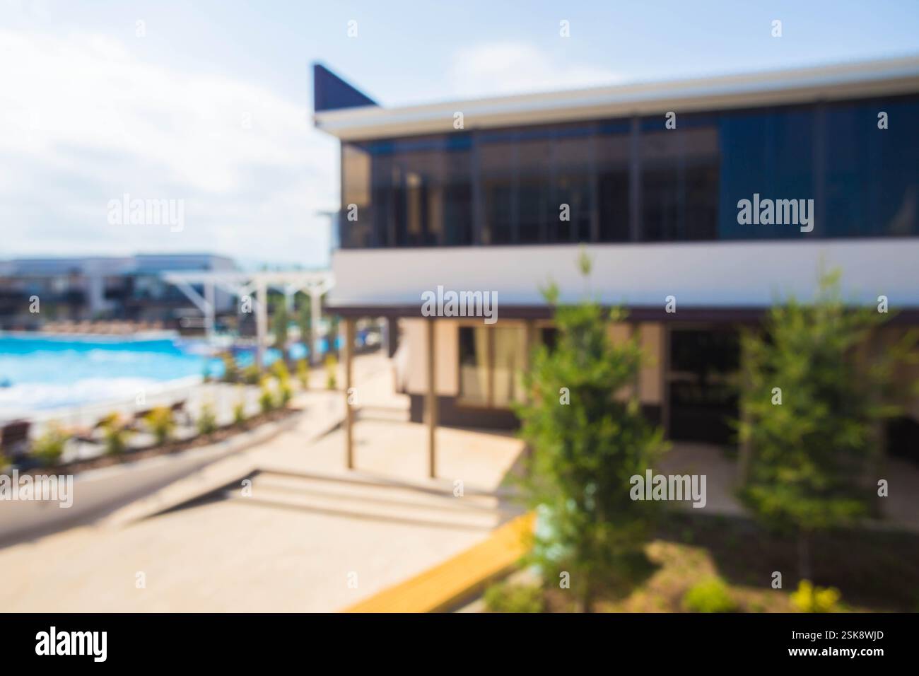 Poolside structure with modern design surrounded by lush greenery in a ...