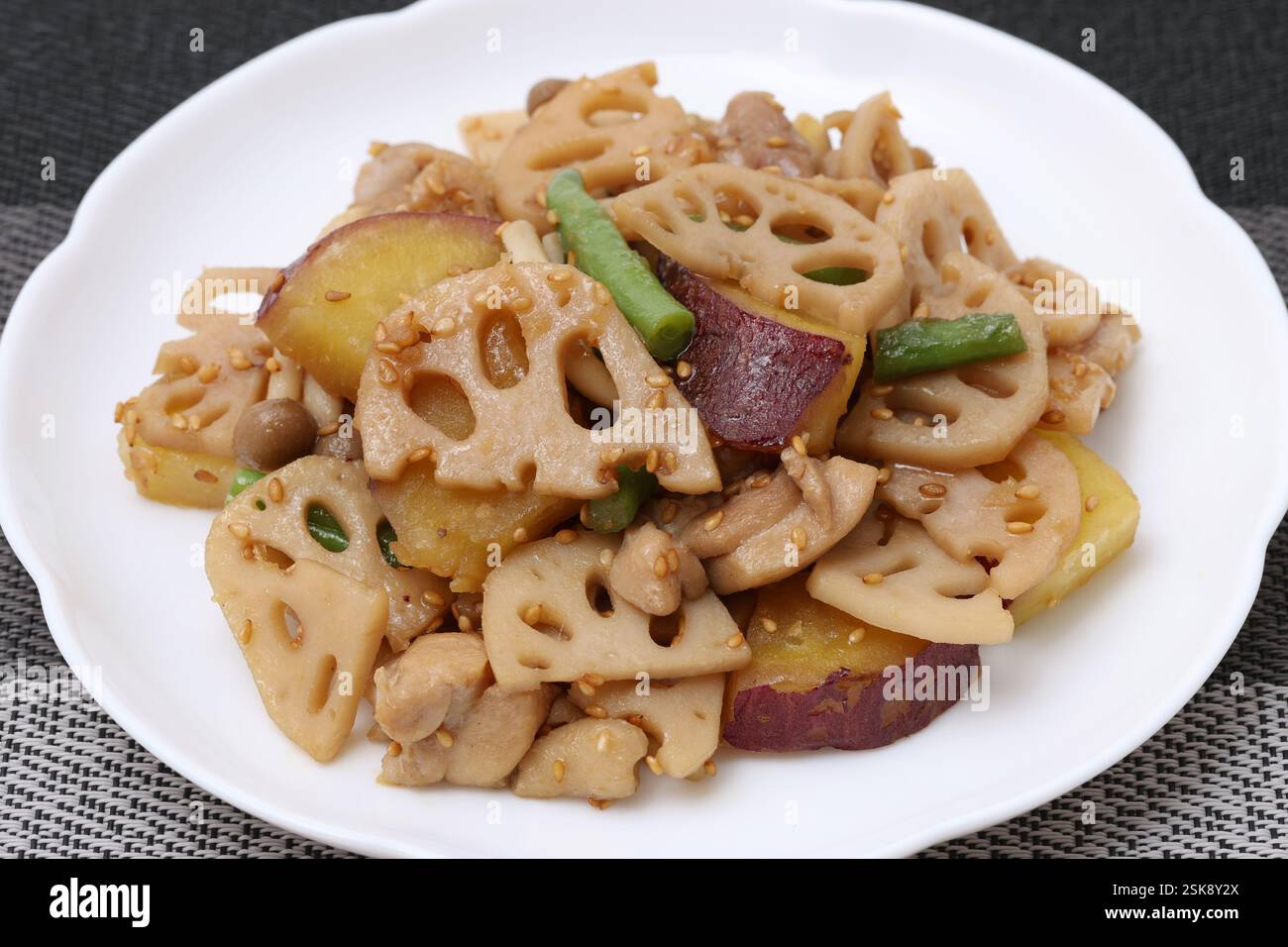 Japanese lotus root and sweet potato mixed dishes in a plate on table ...