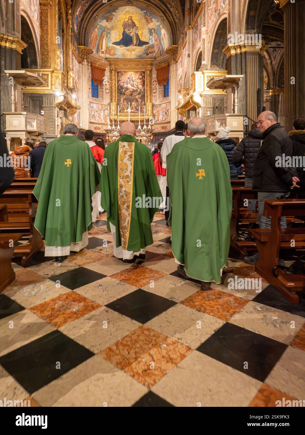 Cremona, Italy - February 9th 2025 Priests wearing green chasubles ...