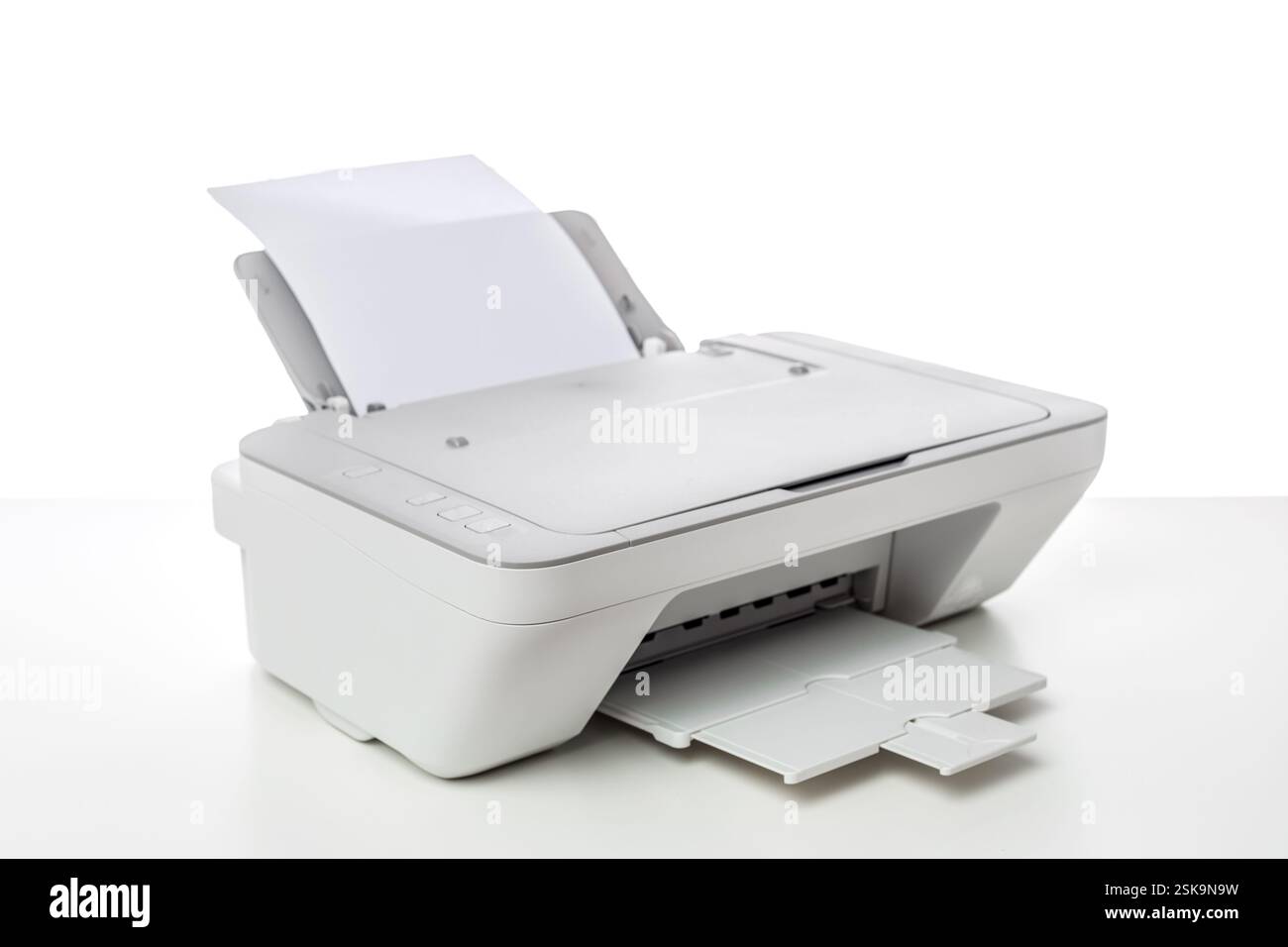 Compact white printer with paper loading in a modern office setting ...