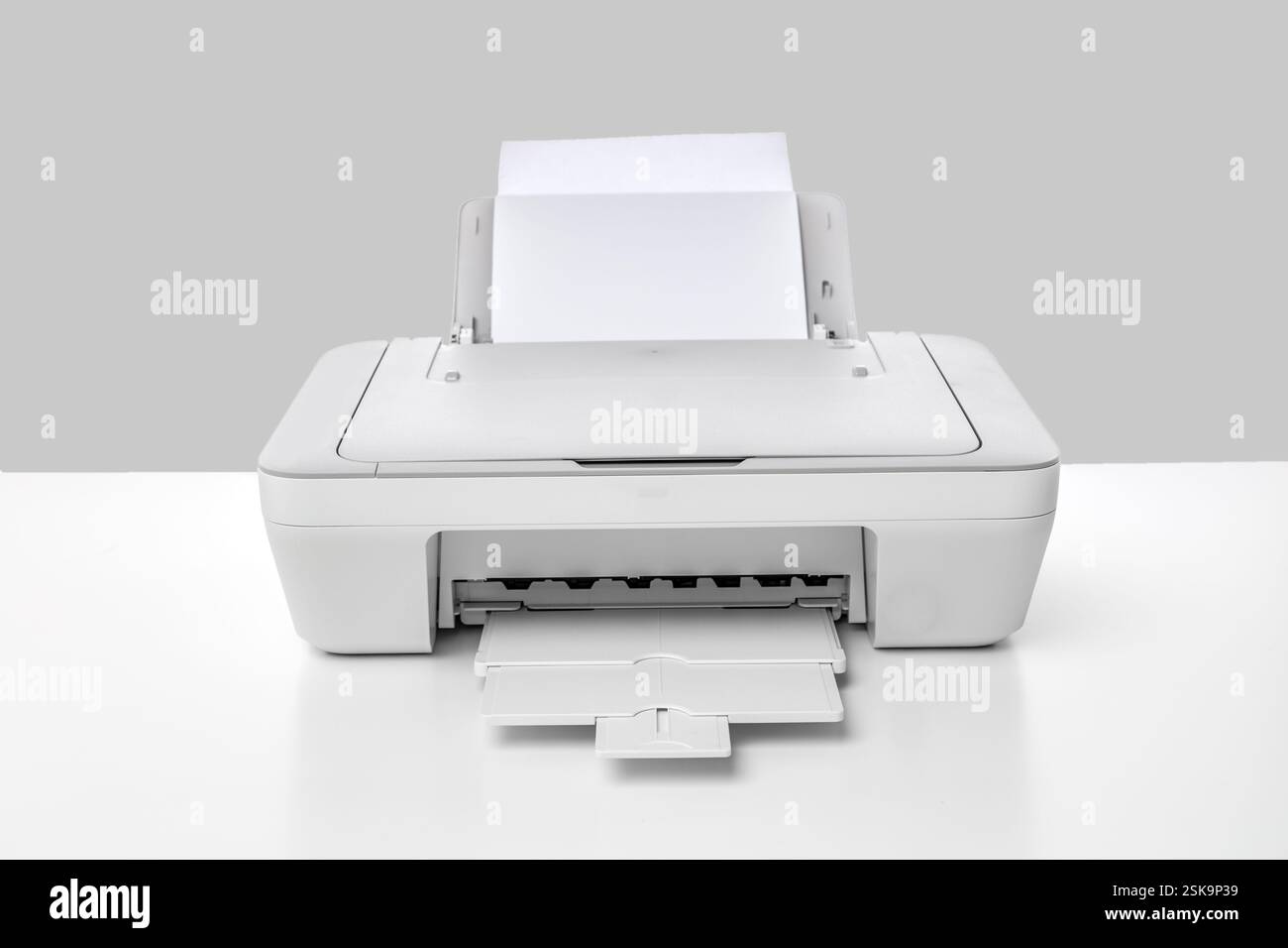 Modern desktop printer with printed paper ready for collection on a ...