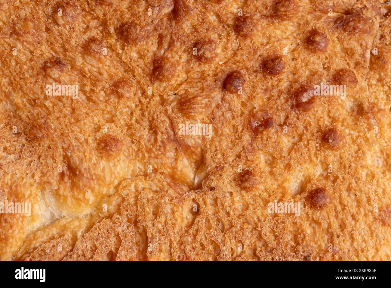 Crispy golden crust of freshly baked bread with porous texture and ...
