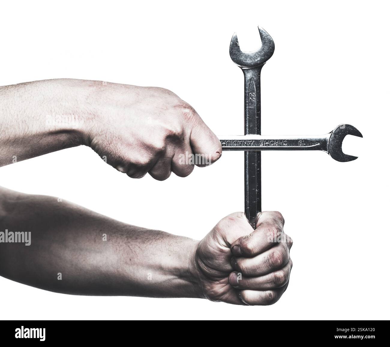 Hand gripping crossed wrenches demonstrating a combination of strength ...