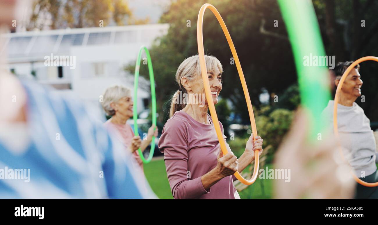 Outdoor, senior people and exercise with hoop for physical fitness ...