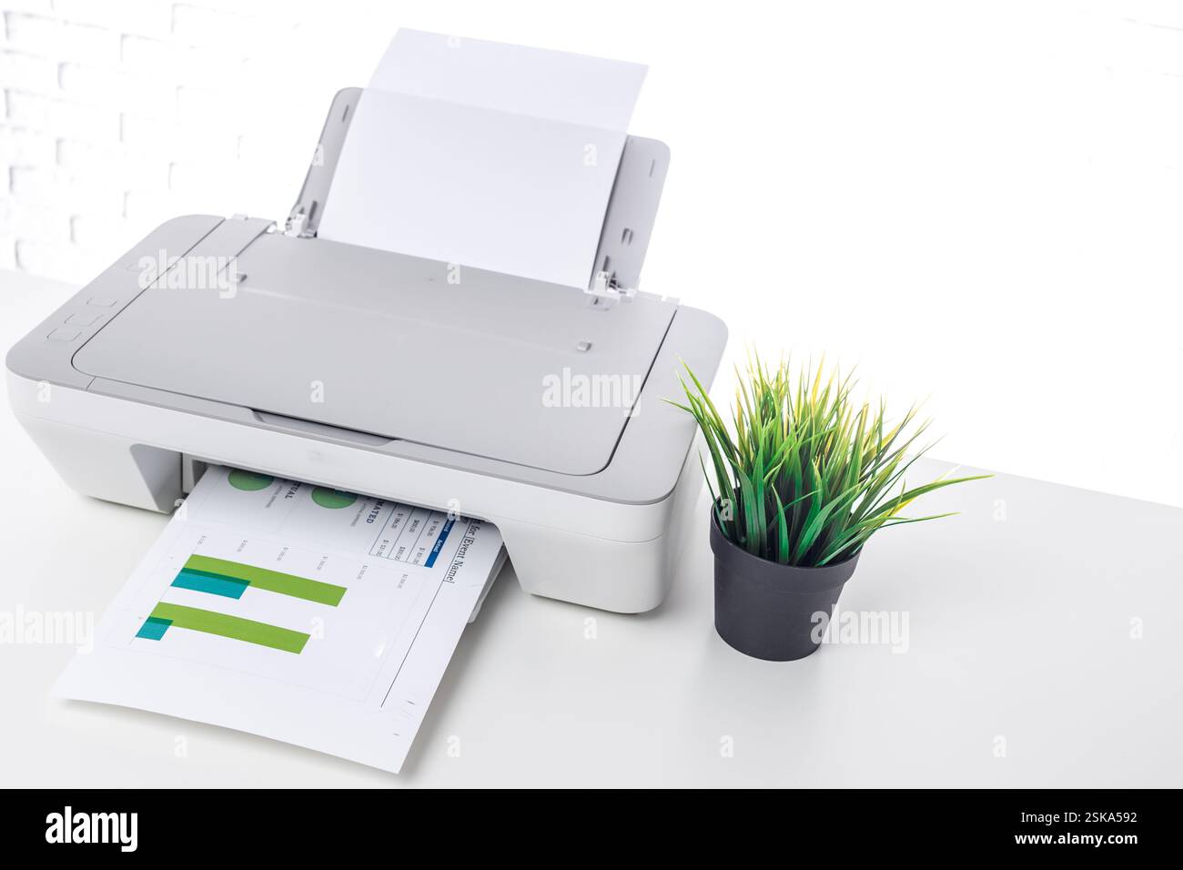 Printer at work in a bright office space with fresh greenery and ...