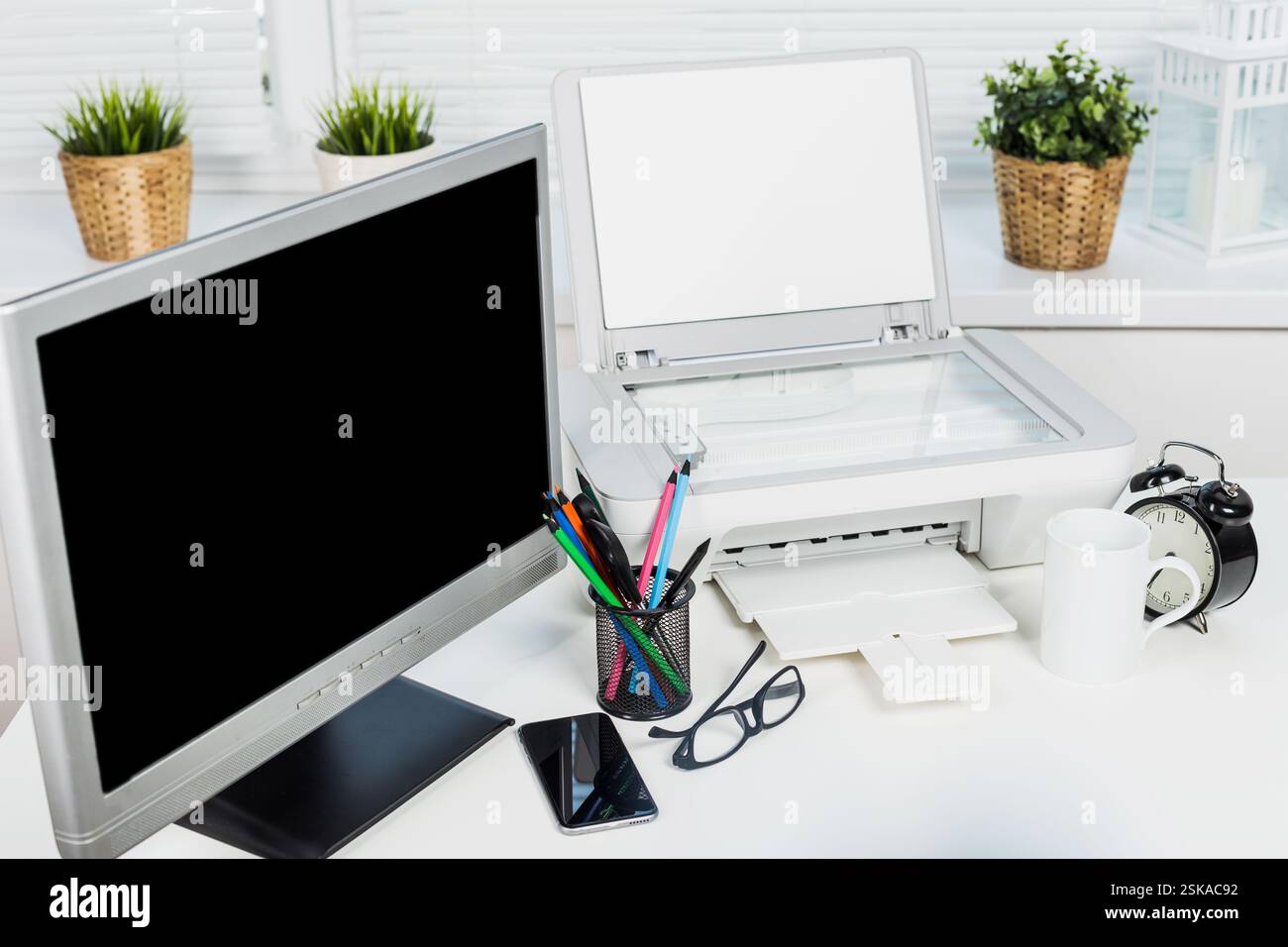 Office workspace with a computer monitor, printer, and stationery set ...