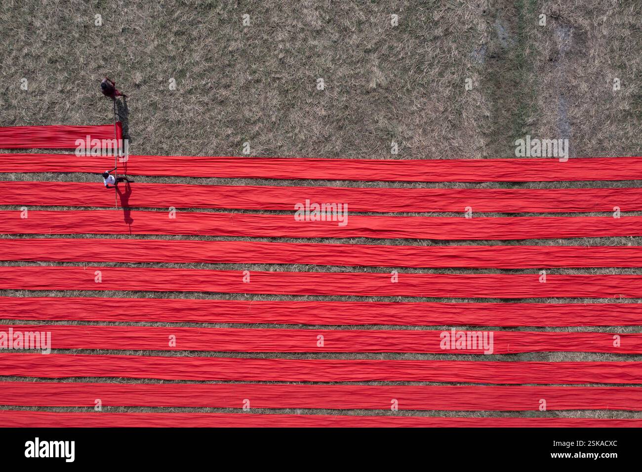 Freshly dyed clothes from dyeing factories are spread out across a vast ...