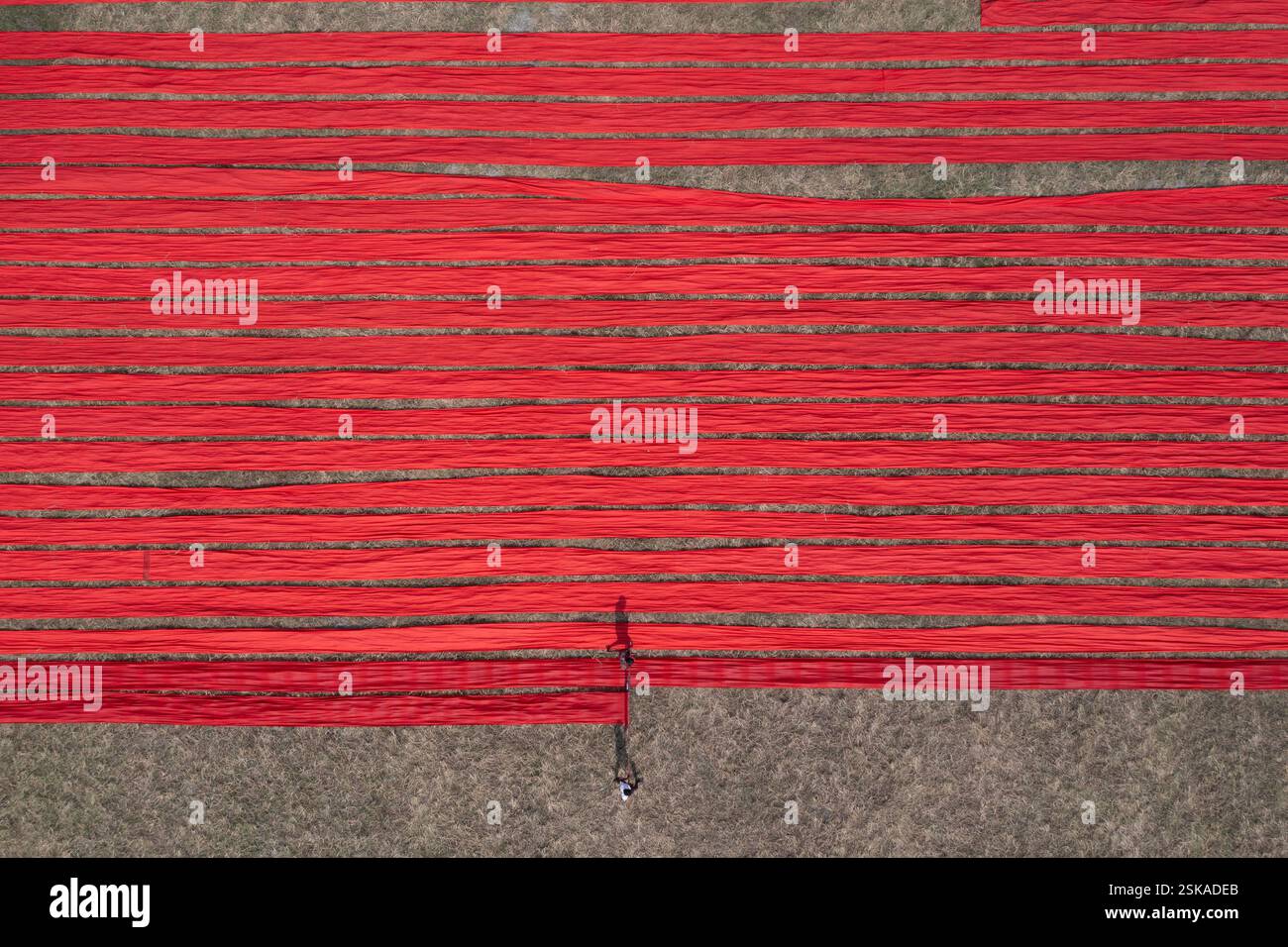 Freshly dyed clothes from dyeing factories are spread out across a vast ...