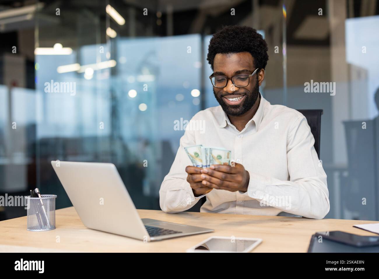 Successful businessman smiling happily counting money cash. Man holding ...