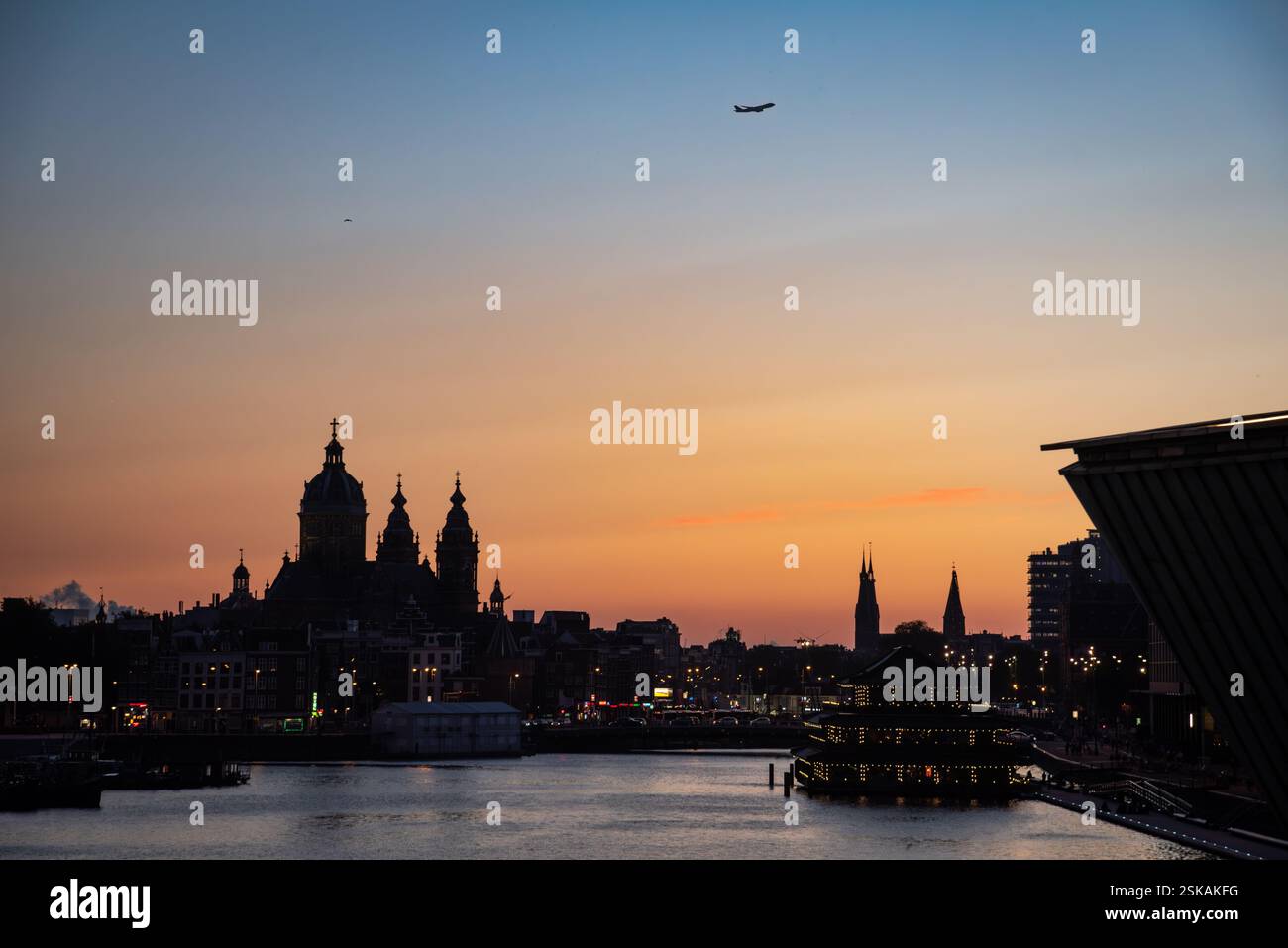 Amsterdam Skyline at Dusk with Illuminated Waters and Basilica of Saint ...