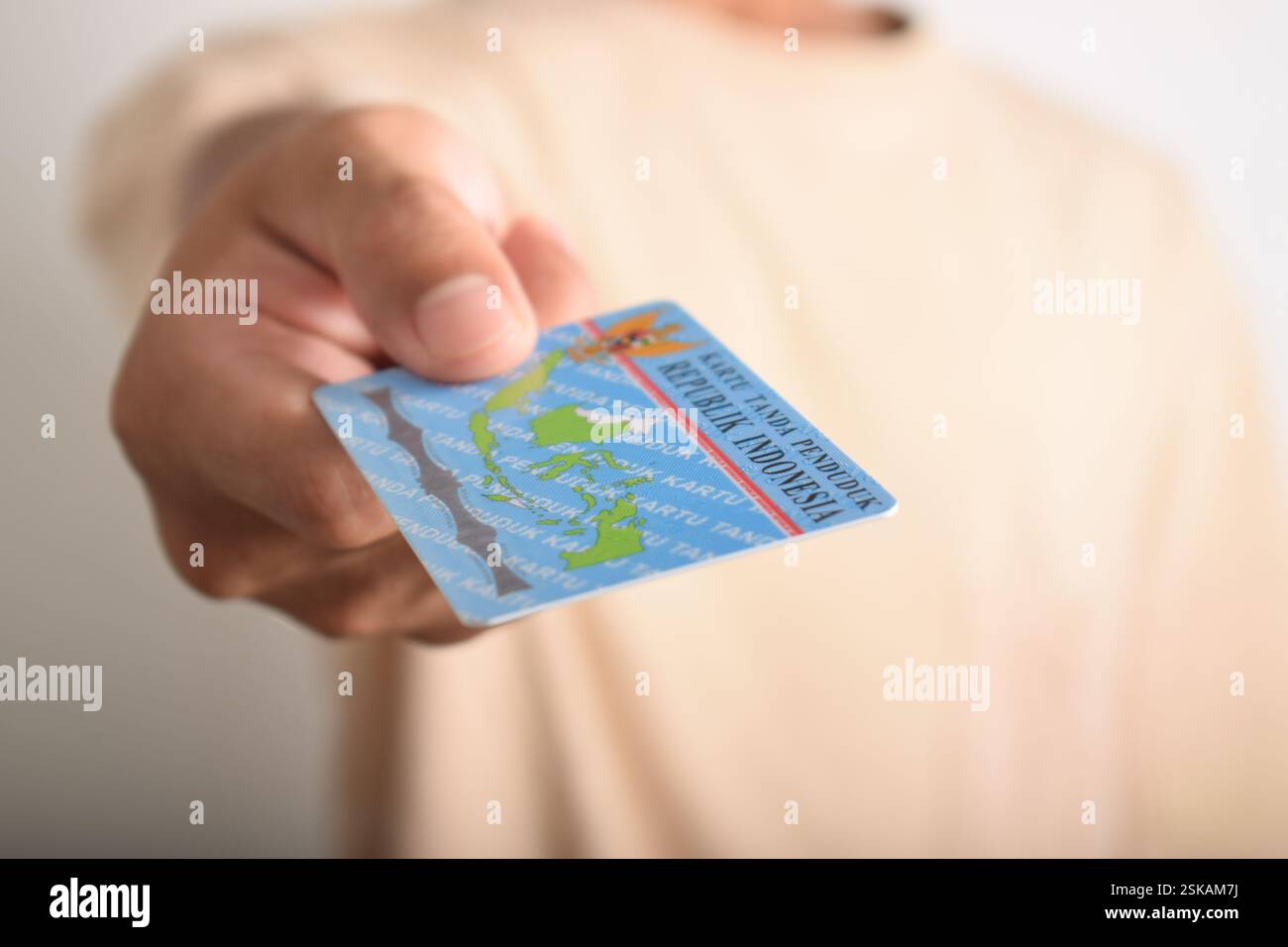 Pasuruan, Indonesia - February 9, 2025: Man giving KTP Kartu Tanda ...