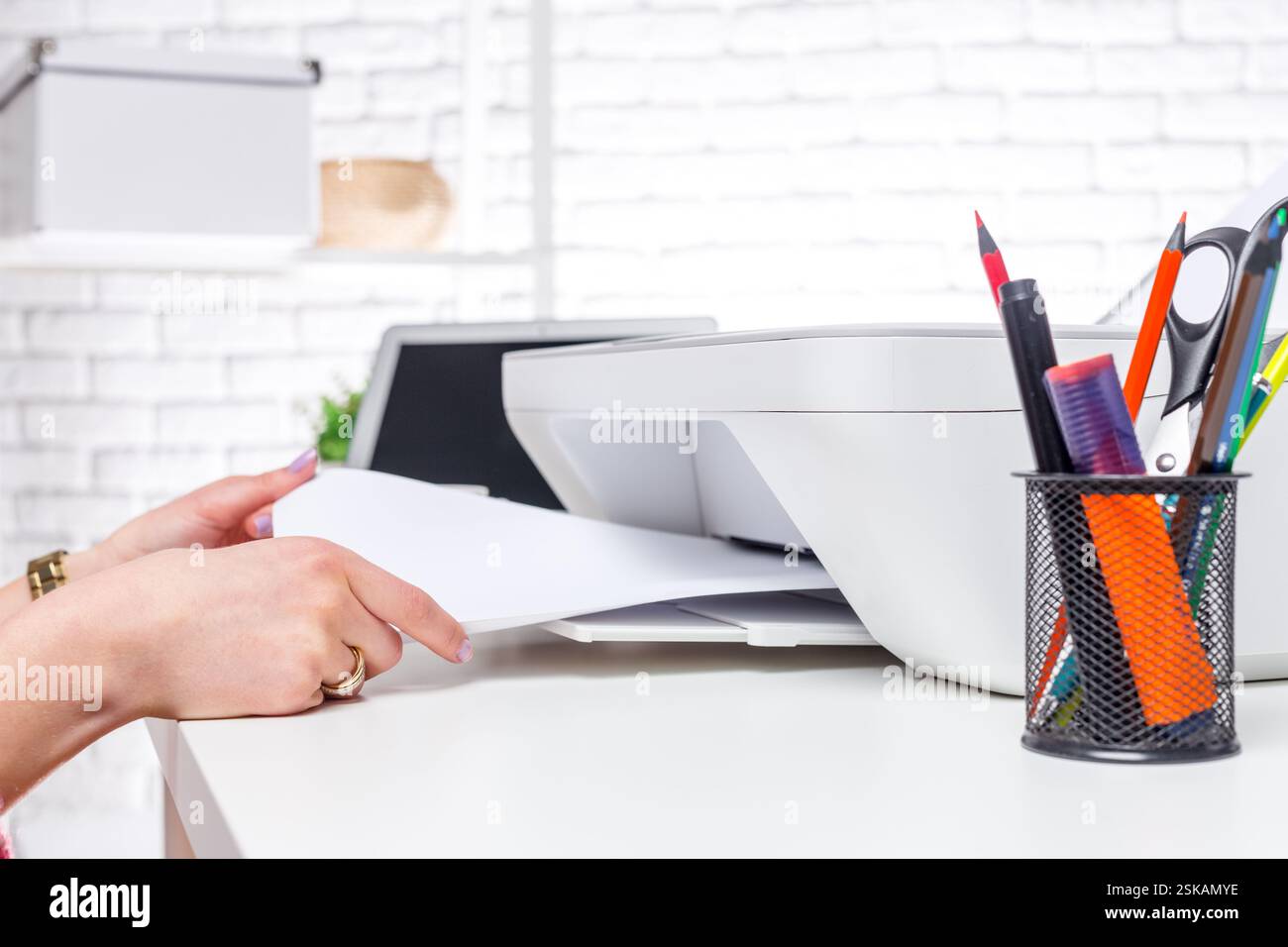 Office printing activity during work hours with a cluttered desk and organized stationery Stock ...