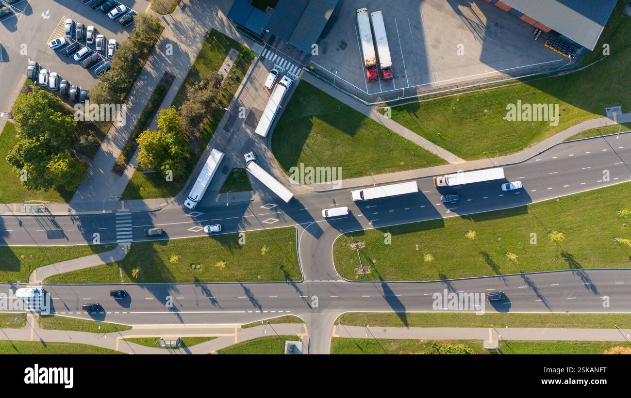 Aerial view of a busy road intersection with several trucks and cars ...
